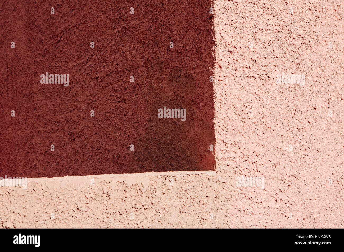 Corner and shadow on the wall of a modern adobe building, close up ...