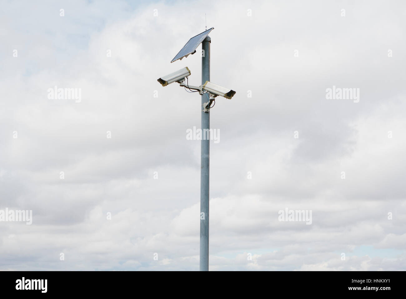 A solar powered surveillance camera on a pole Stock Photo - Alamy