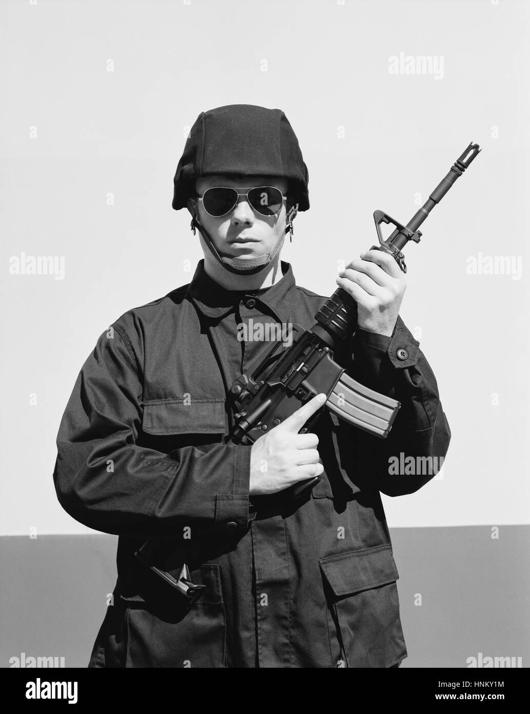 Man wearing special forces uniform and holding high powered semi ...