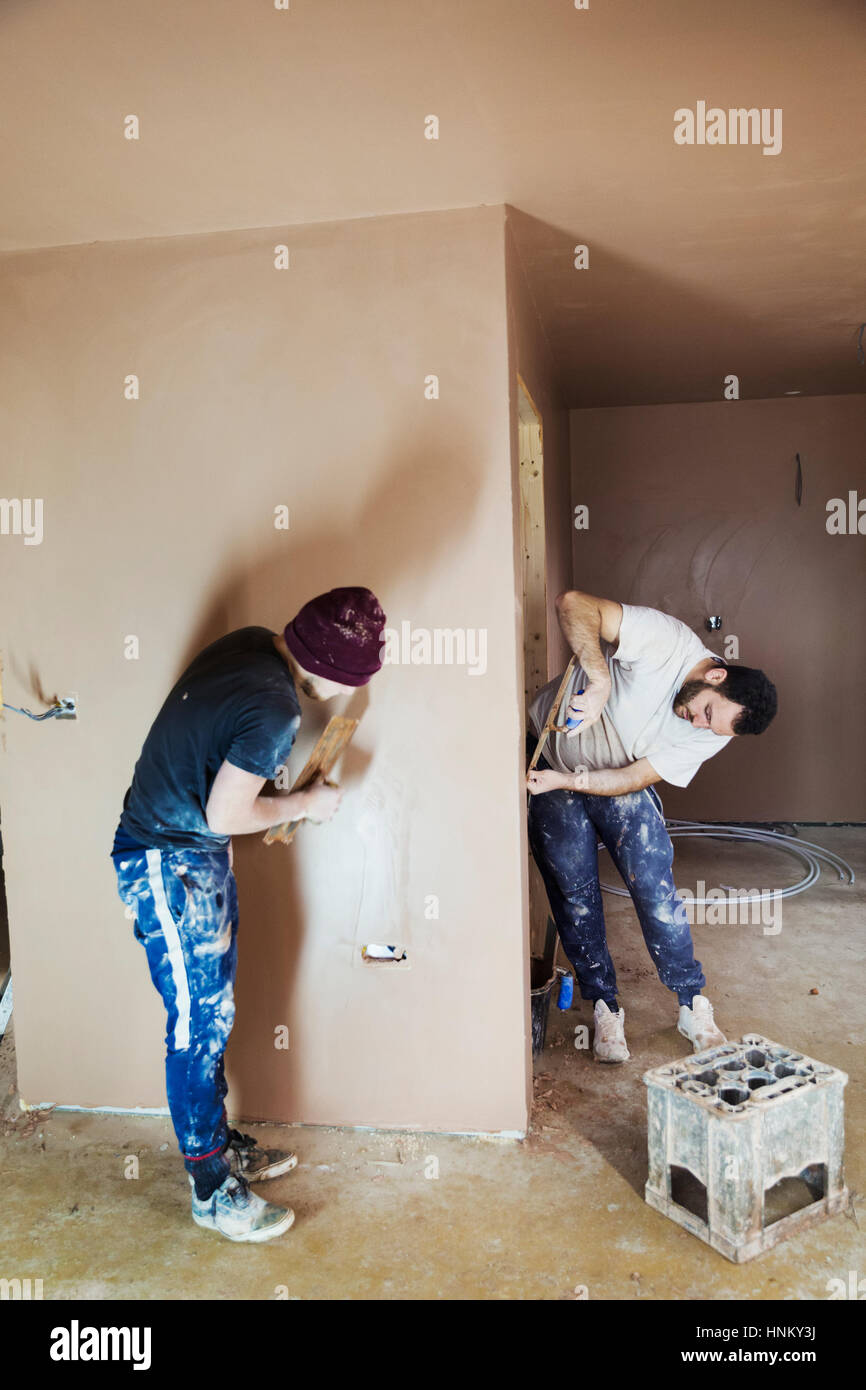 Two workmen working on a construction site Stock Photo - Alamy