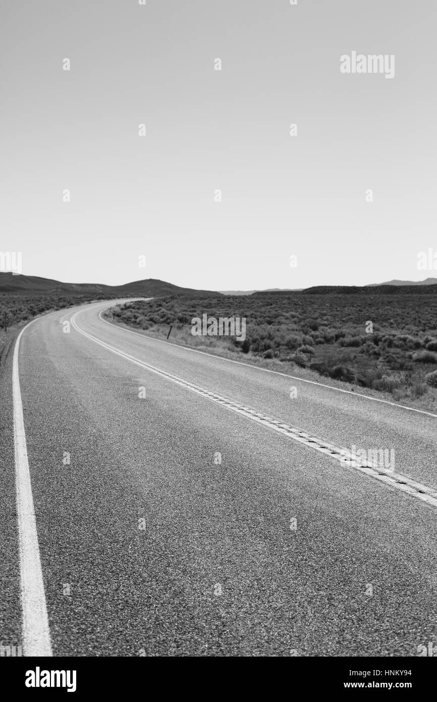 Remote, rural road curving around a corner into the distance Stock ...