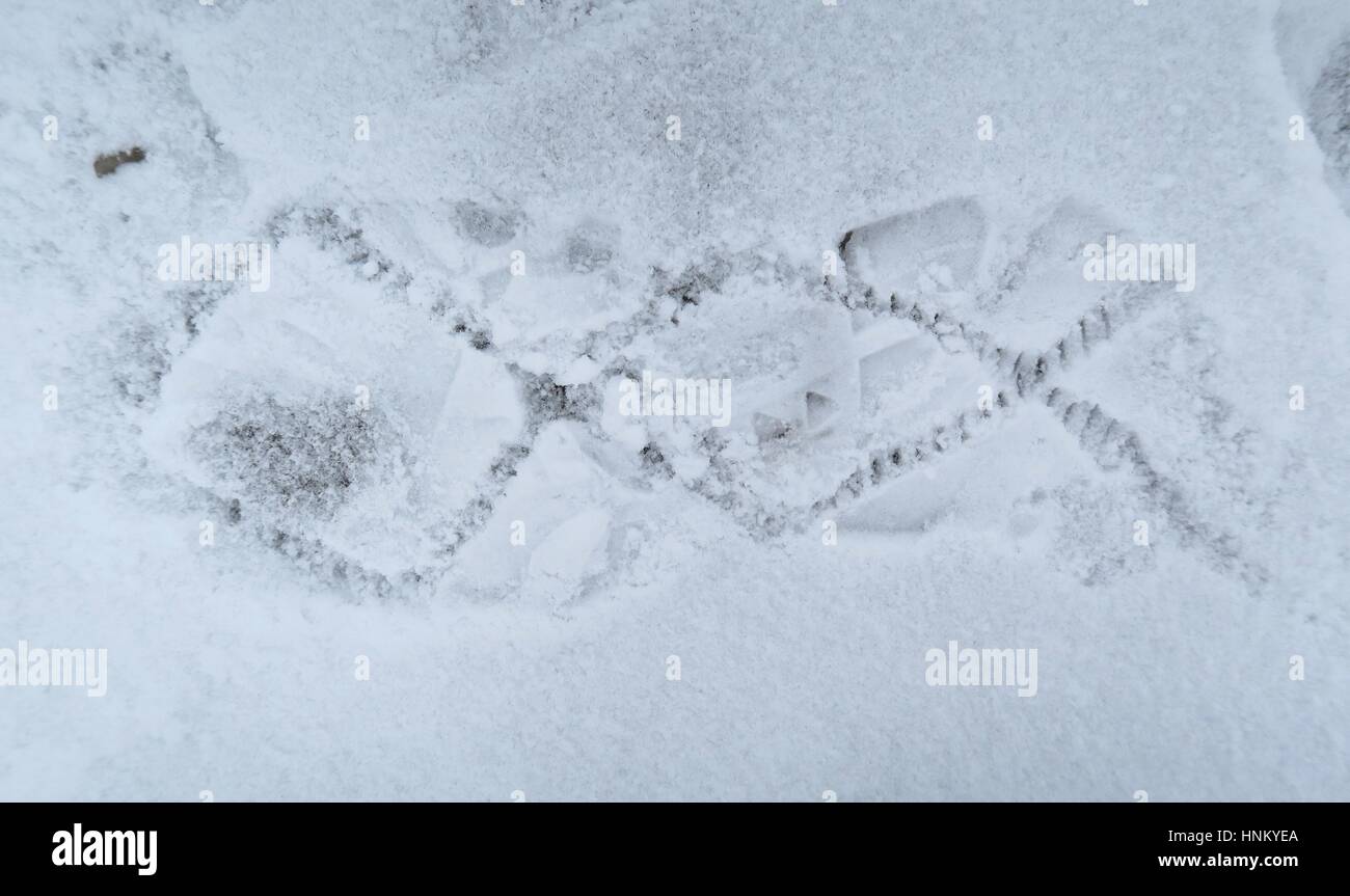Tracking boot footprint on snow. Close-up from above shot Stock Photo ...