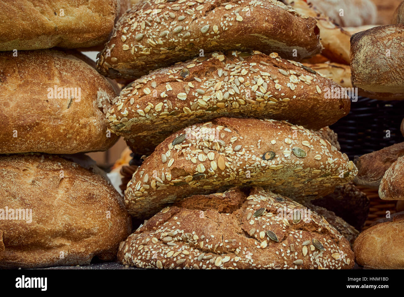 A stack of artisan seeded bread loaves - detail Stock Photo - Alamy