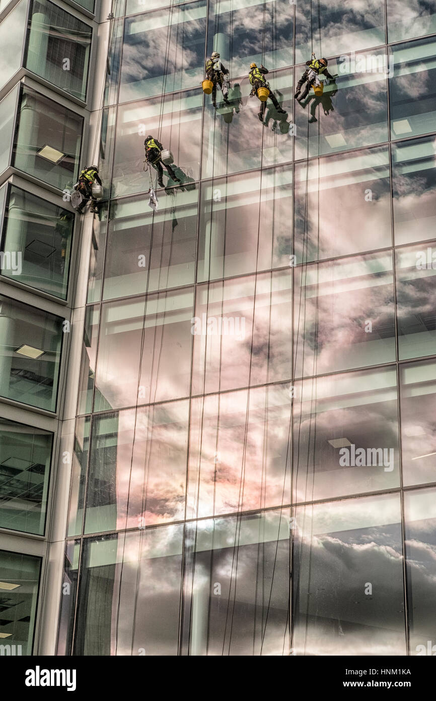 Climbers washing windows on modern skyscraper building,London,England ...