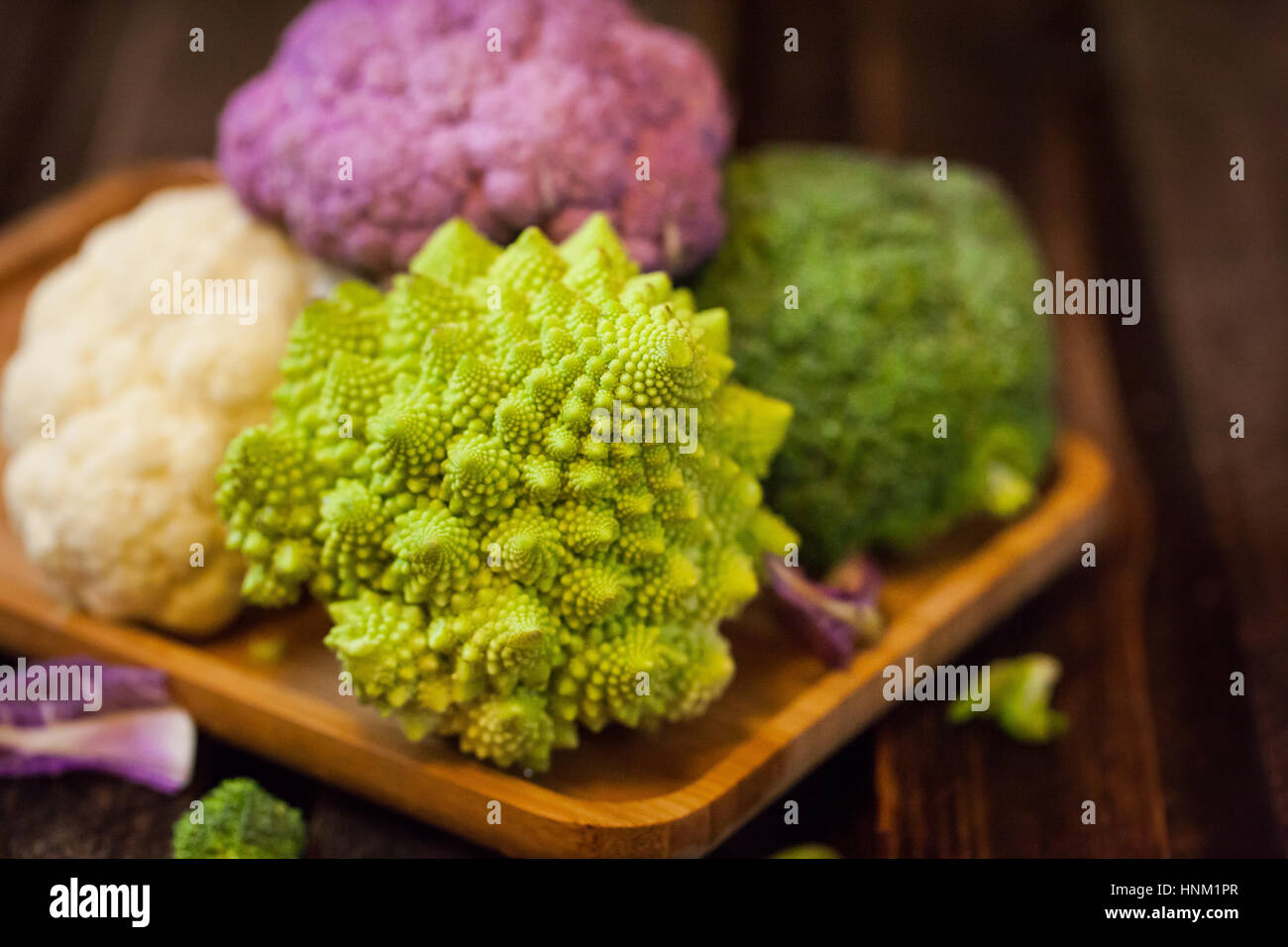 Fresh organic white and purple cauliflower, broccoli, romanesco in ...