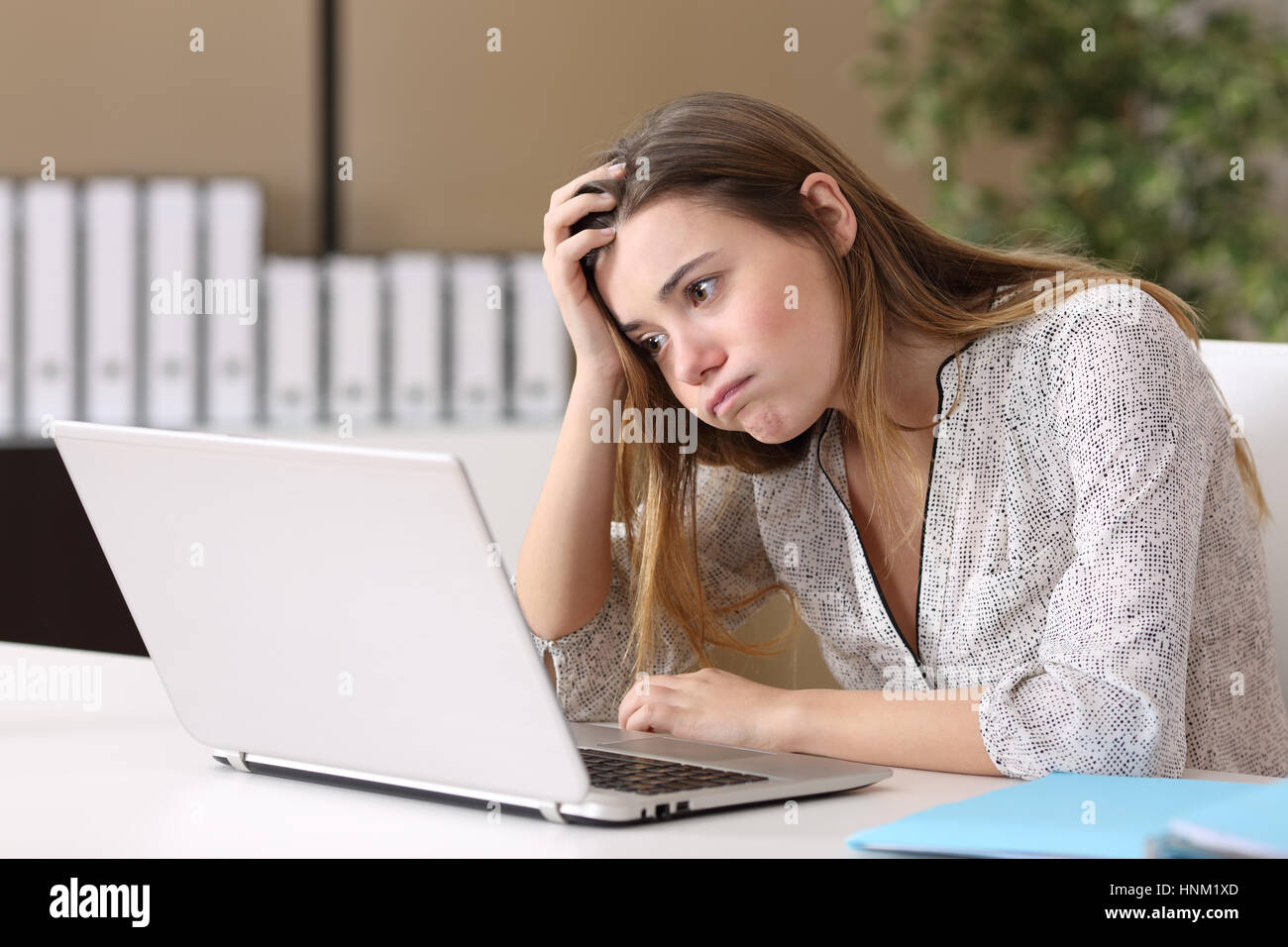 Frustrated intern trying to work on line with a laptop in a difficult ...