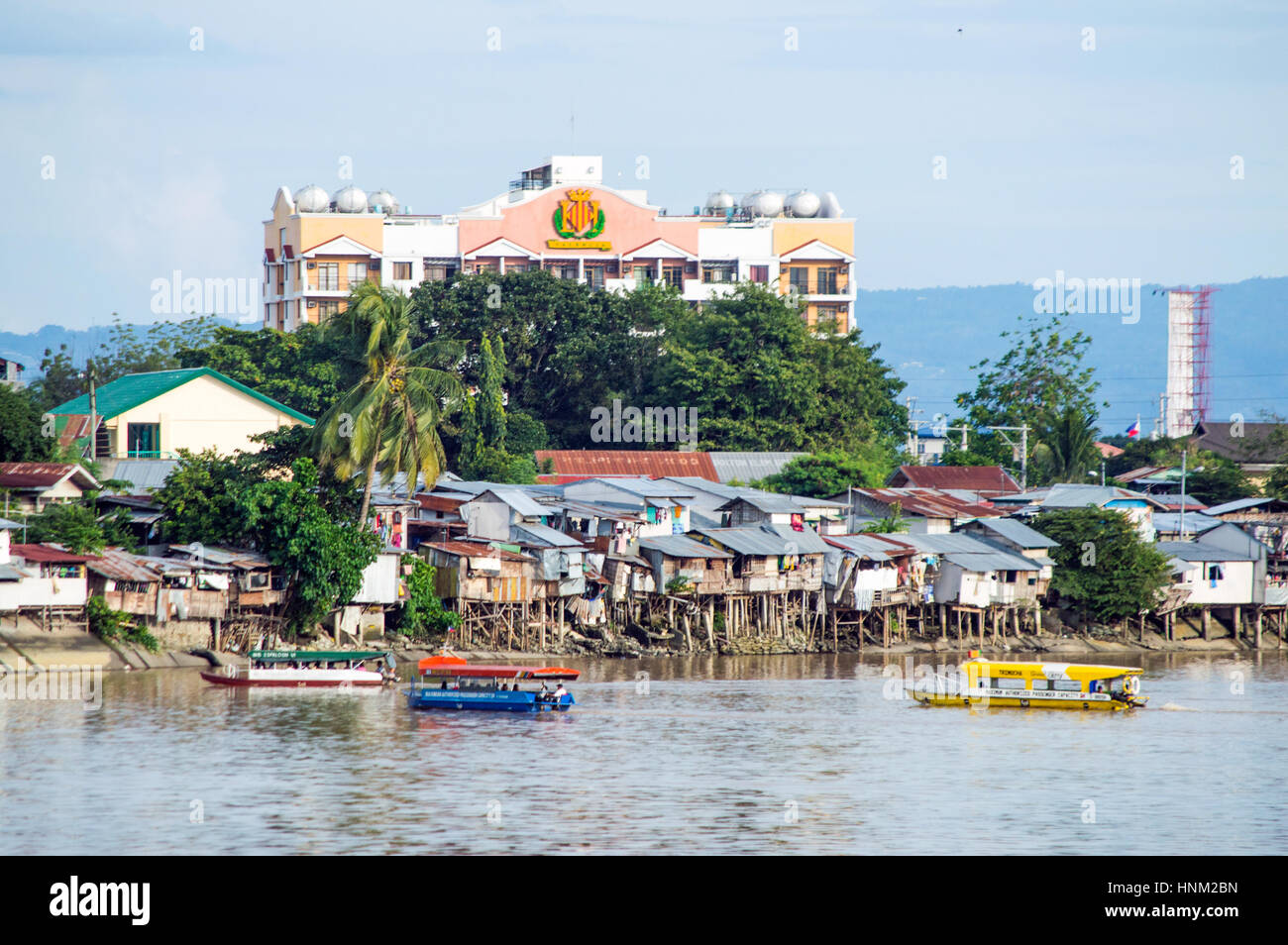 River ferries and slum housing along Bangkerohan River, Davao, Davao ...