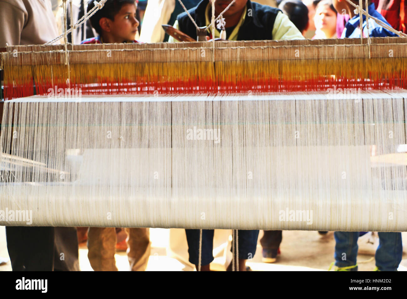 Weaver weaving the cloth on a hand loom in surajkund fair Stock Photo ...