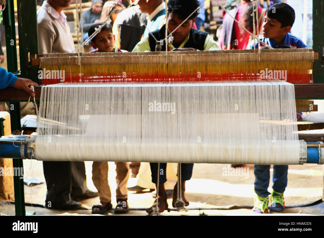 Weaver weaving the cloth on a hand loom in surajkund fair Stock Photo ...