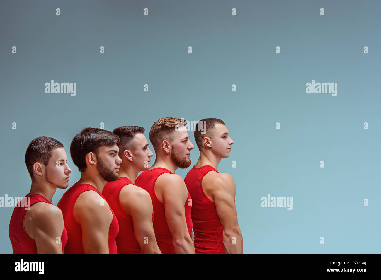The two gymnastic acrobatic caucasian men posing in on gray studio ...