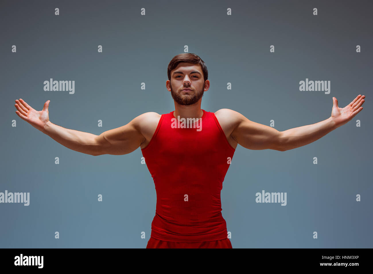The two gymnastic acrobatic caucasian men posing in on gray studio ...