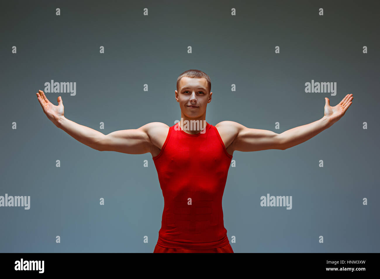 The two gymnastic acrobatic caucasian men posing in on gray studio ...