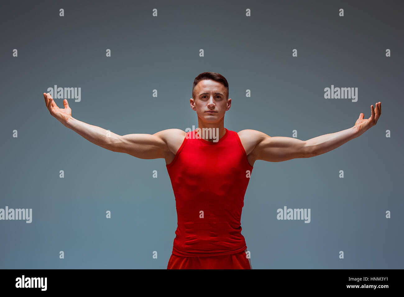 The two gymnastic acrobatic caucasian men posing in on gray studio ...