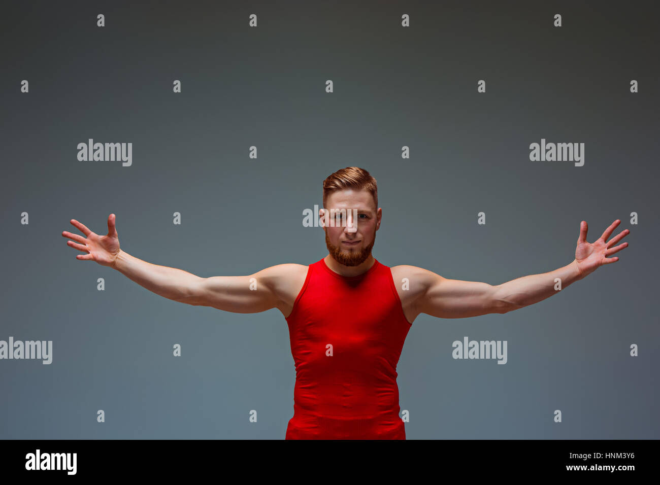 The two gymnastic acrobatic caucasian men posing in on gray studio ...