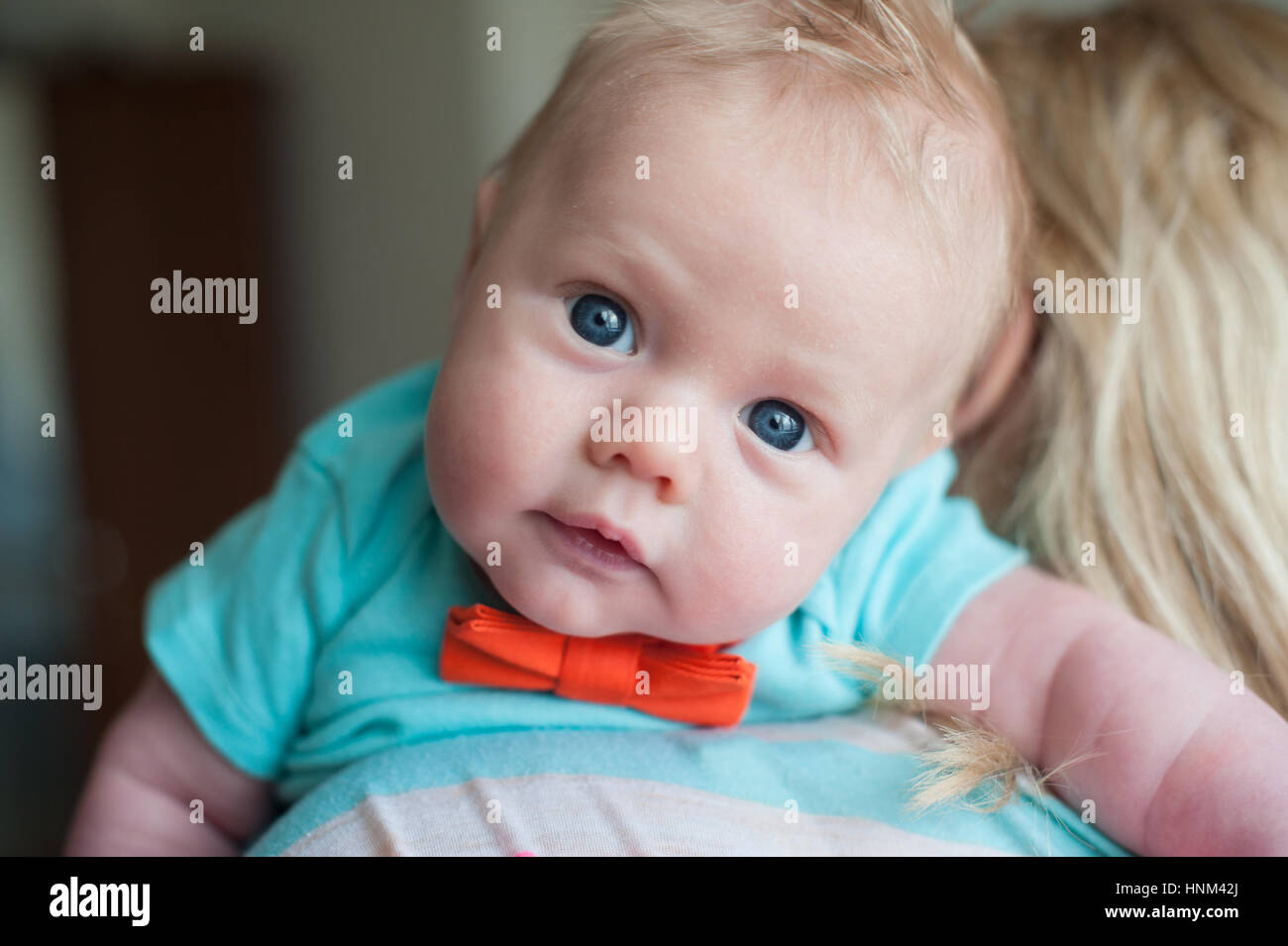beautiful little kid looking over mother shoulder Stock Photo - Alamy