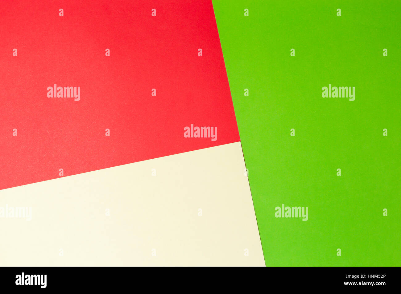 Greenery, red and yellow colored paper background Stock Photo - Alamy