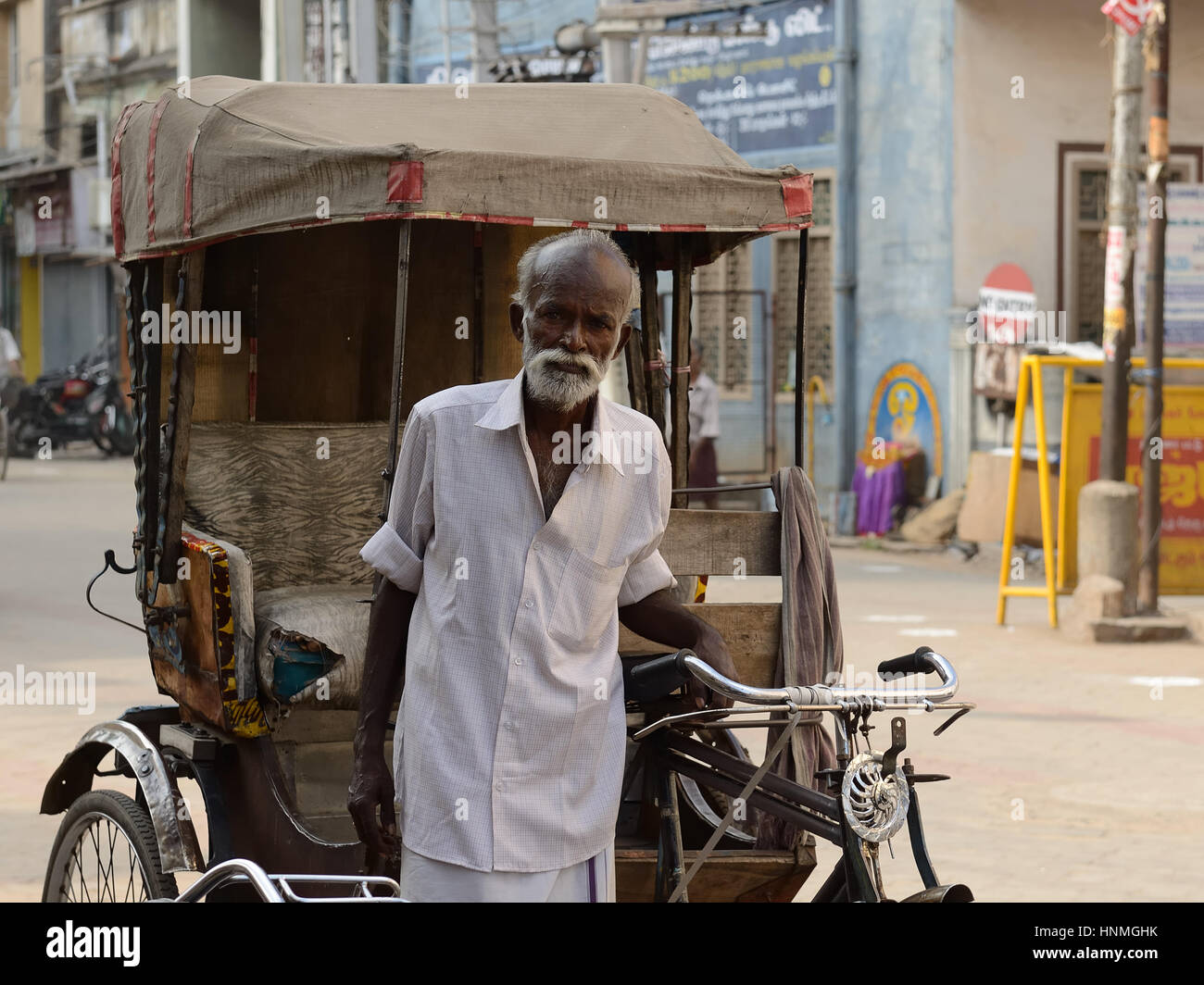 INDIA, MADURAJ - MARCH 05: Rickshaw driver with one's rickshaw in the ...