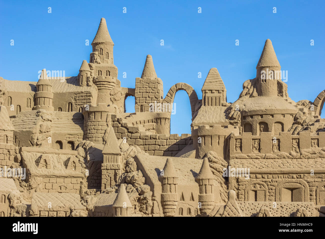 Sand castle with several towers against a blue sky Stock Photo - Alamy