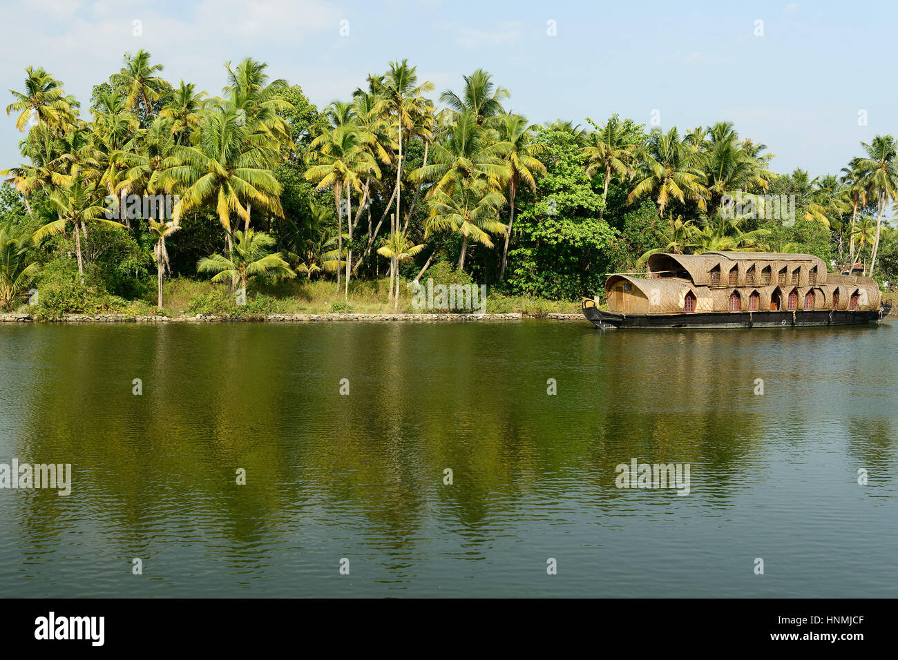 India, Coco trees reflection and beautifoull house boat at back waters ...