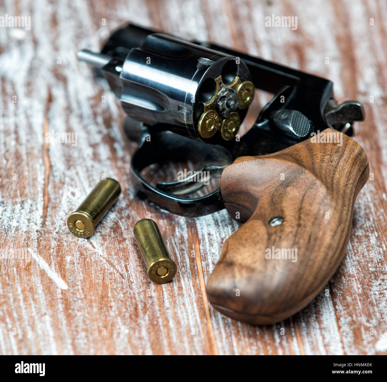 small revolver lying on a wooden table, shallow depth of field Stock ...