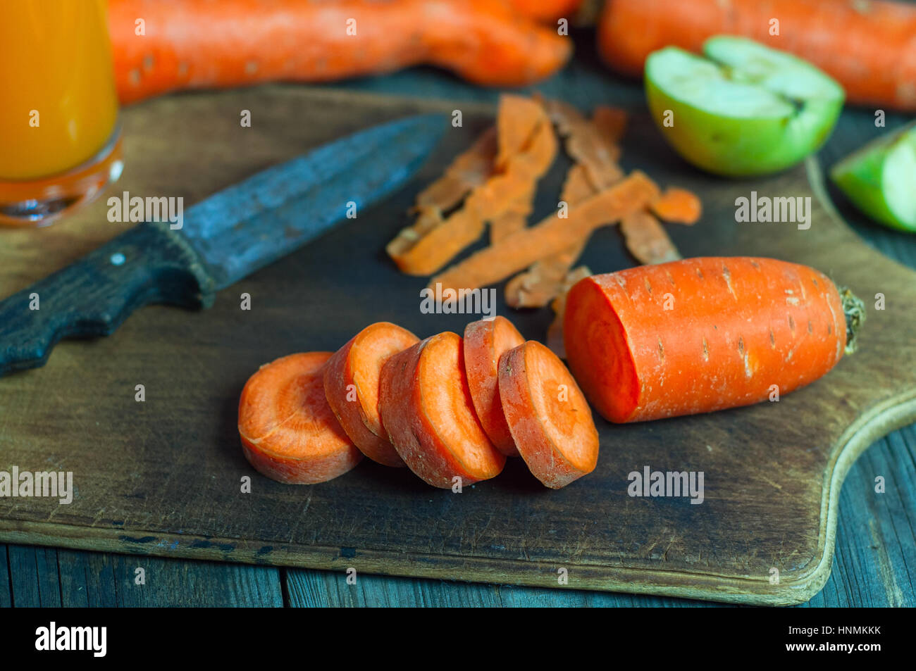 Cut into round slices of carrot on the kitchen brown wooden board ...