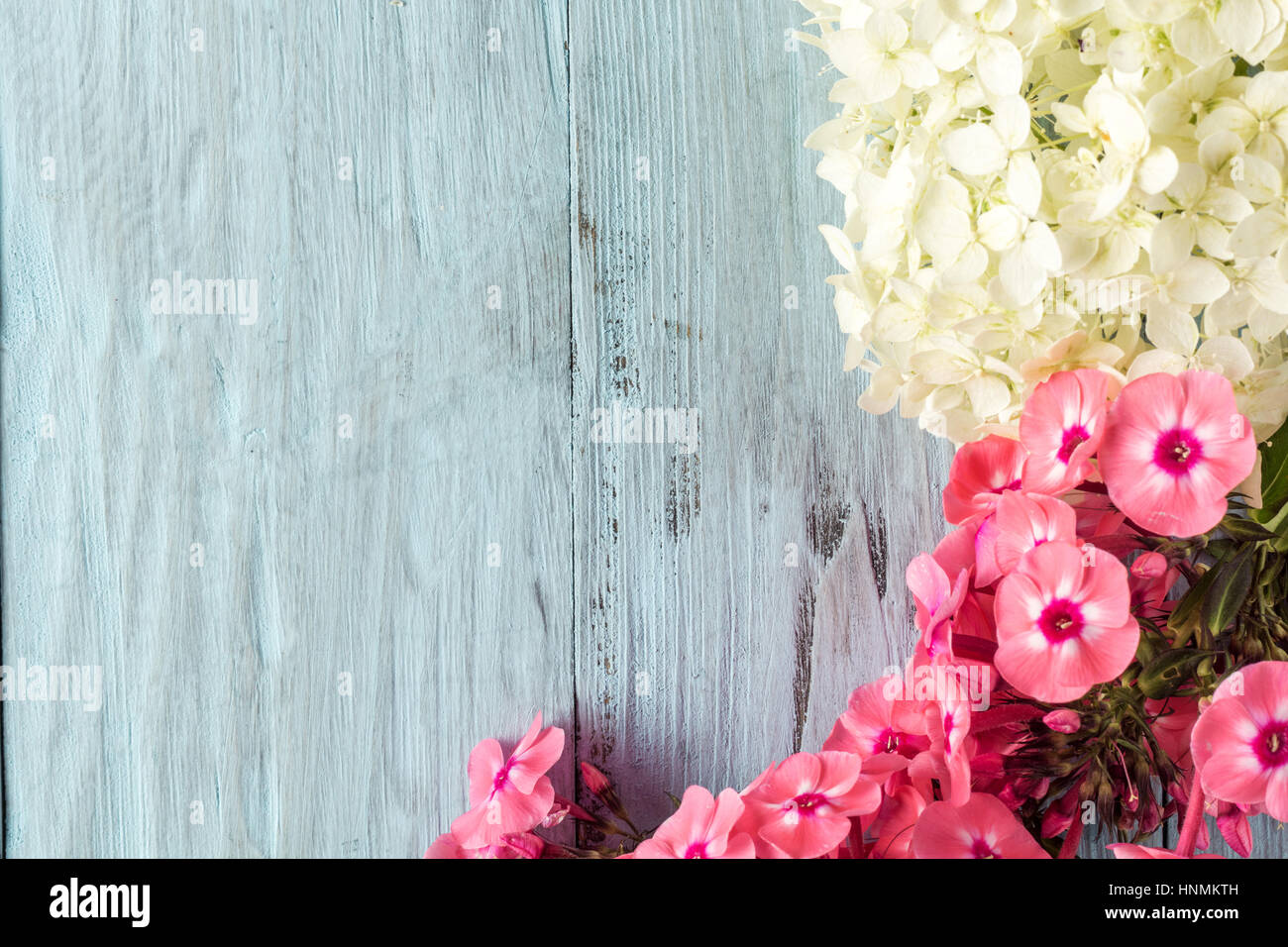 frame of flowers, background blue boards Stock Photo - Alamy