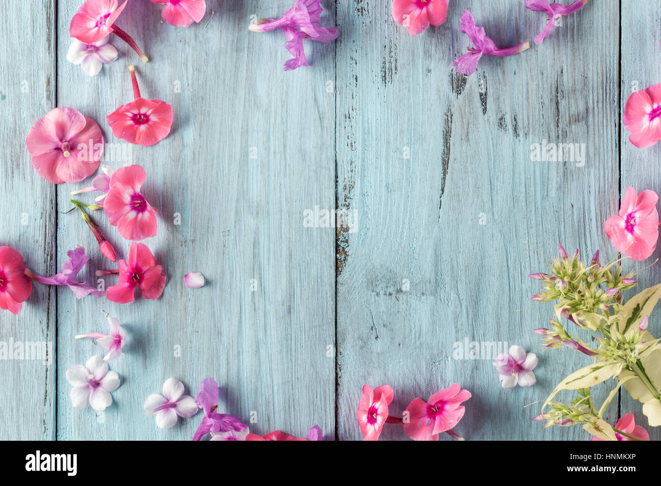 frame of flowers, background blue boards Stock Photo - Alamy