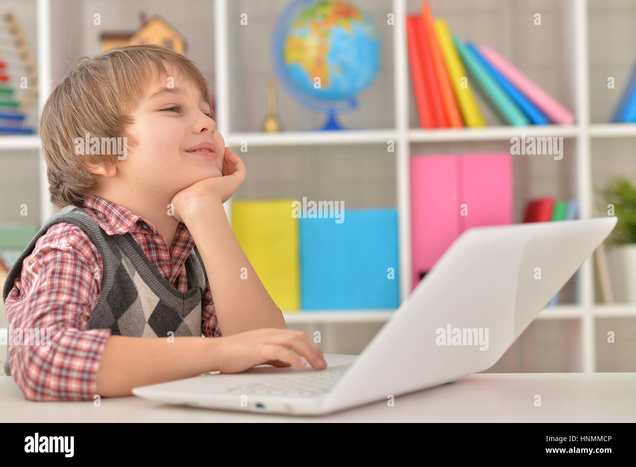 Boy using laptop Stock Photo - Alamy