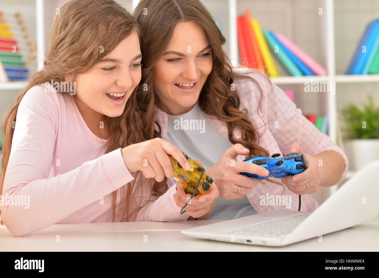 Mother and daughter playing video games Stock Photo - Alamy