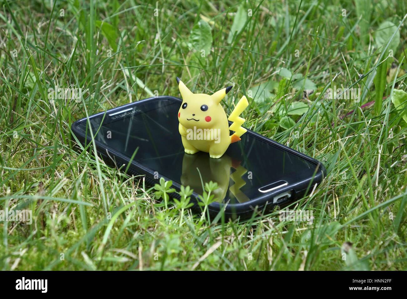 ILLUSTRATION - The Pokémon character Pikachu on a mobile phone lying in ...