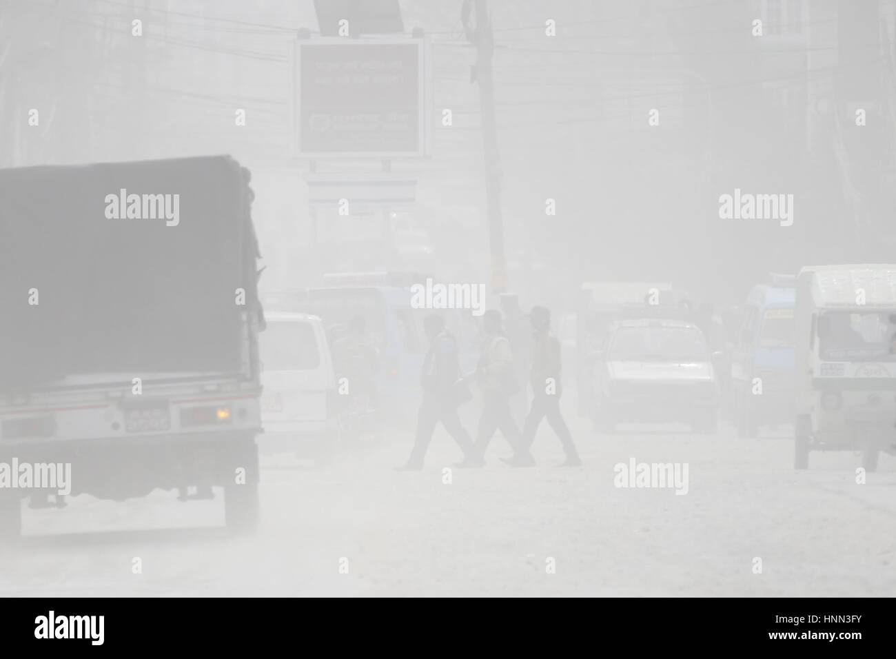 Kathmandu, Nepal. 15th Feb, 2017. People cross a polluted road in ...