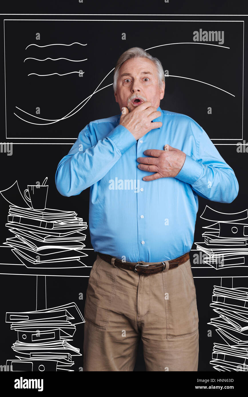 Nice aging man standing among piles of paper Stock Photo - Alamy