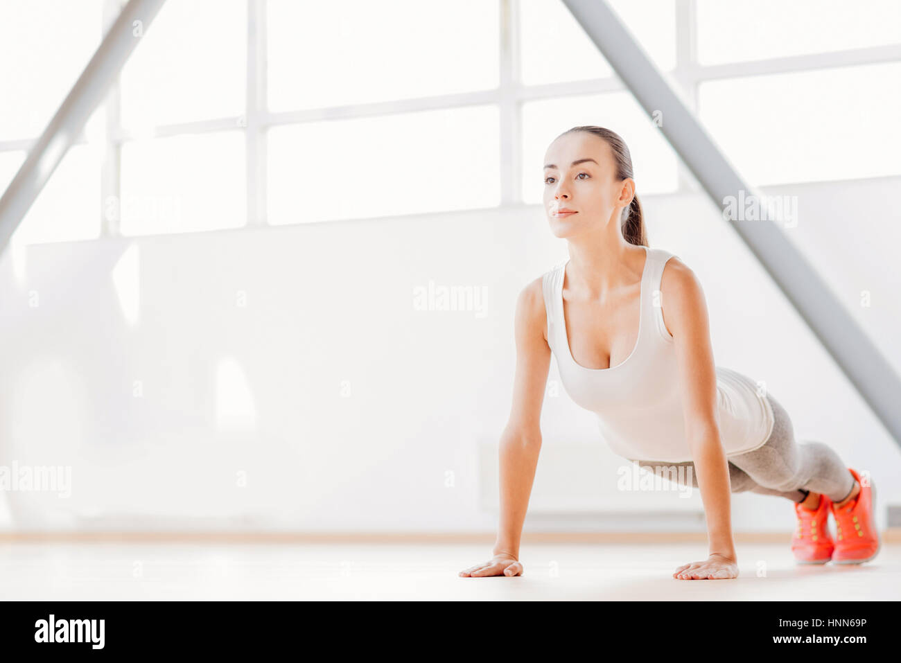 Beautiful concentrated woman doing push ups Stock Photo - Alamy