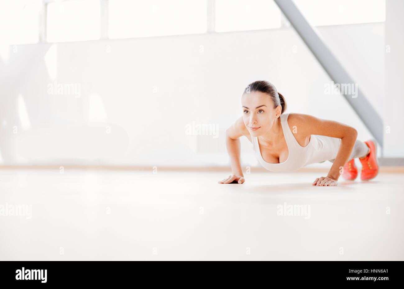 Positive well built woman developing her strength Stock Photo - Alamy