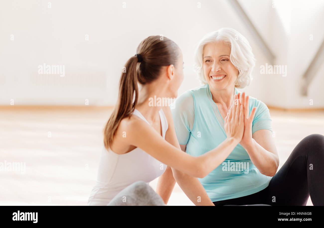 Happy nice women giving high five Stock Photo - Alamy