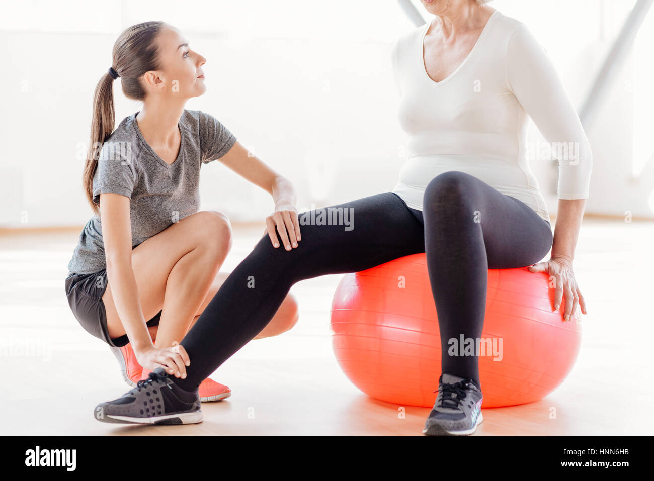 Nice young coach working out with an elderly woman Stock Photo - Alamy