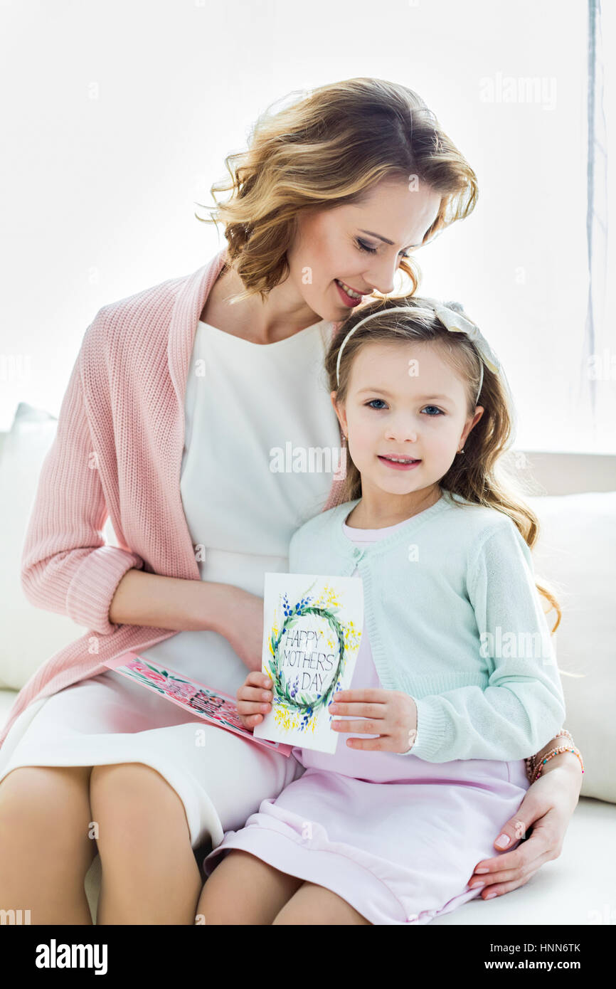 Beautiful mother and daughter with cards Stock Photo - Alamy