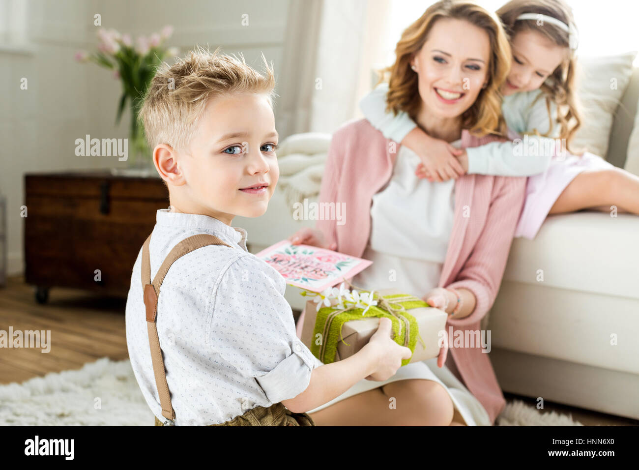 Boy presenting gift to mother Stock Photo - Alamy