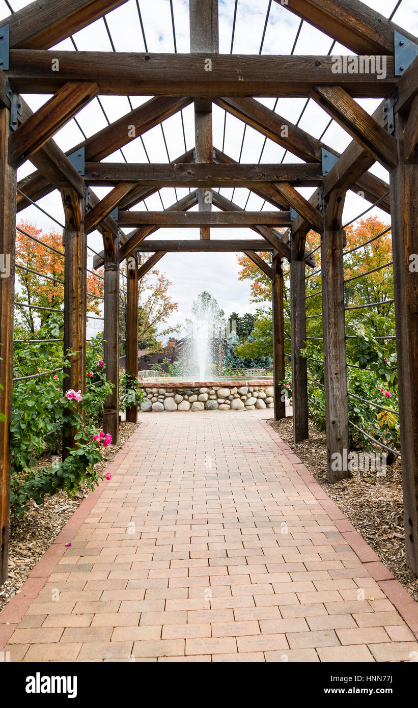 Wood rose trellis over brick walkway in garden Stock Photo - Alamy