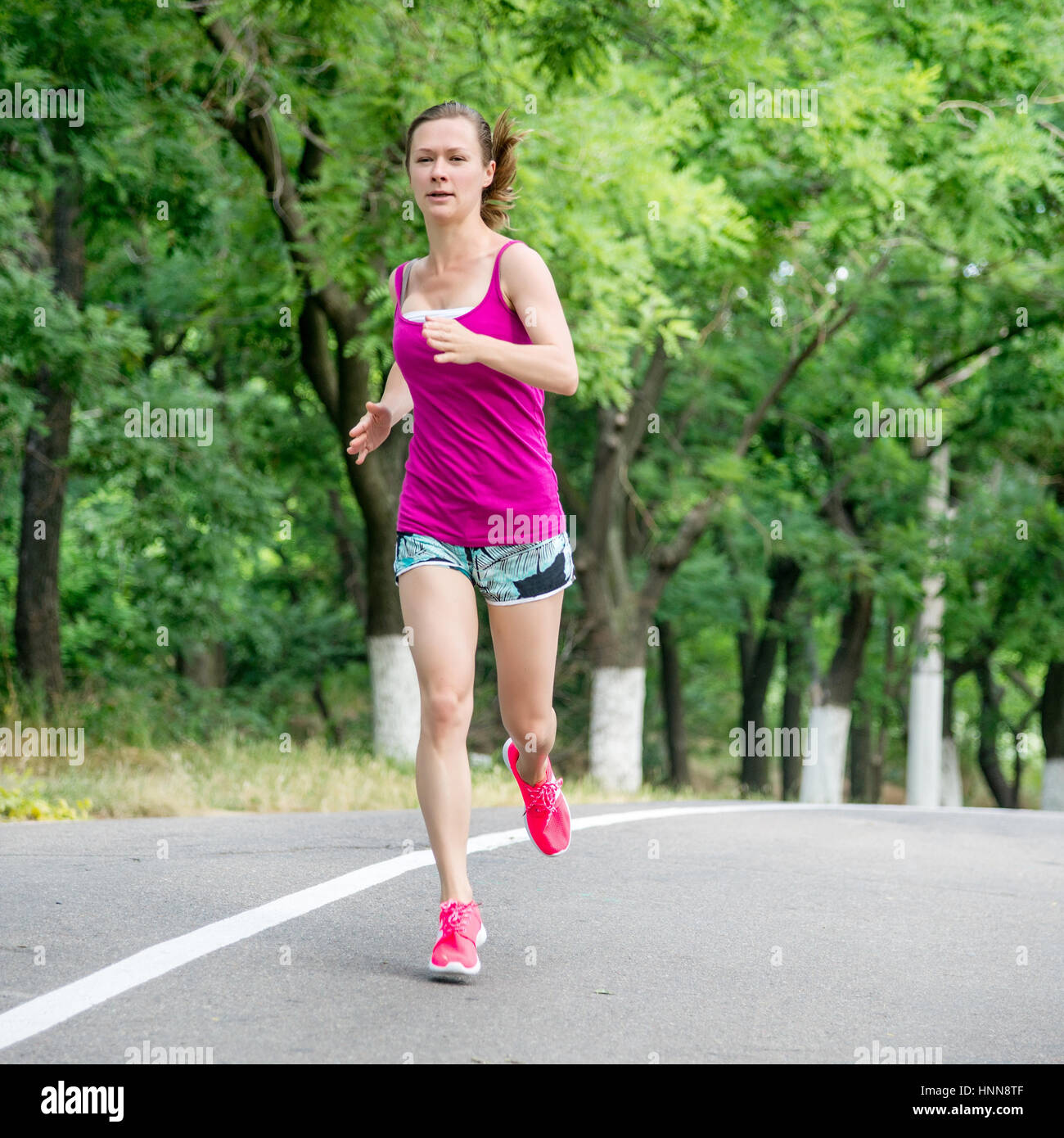 Young woman running Stock Photo - Alamy