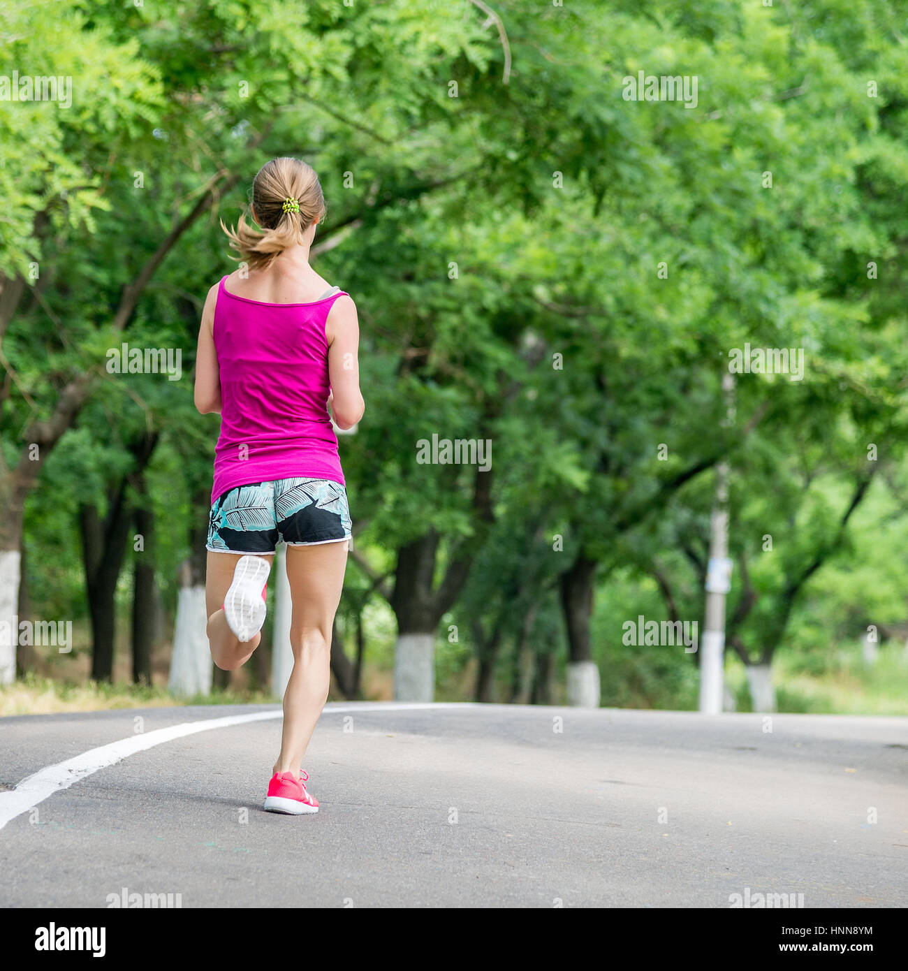 Young woman running Stock Photo - Alamy