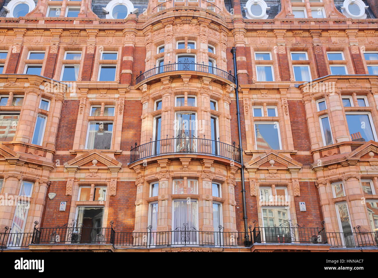 LONDON, UK - FEBRUARY 13, 2017: Red brick Victorian houses facades in ...