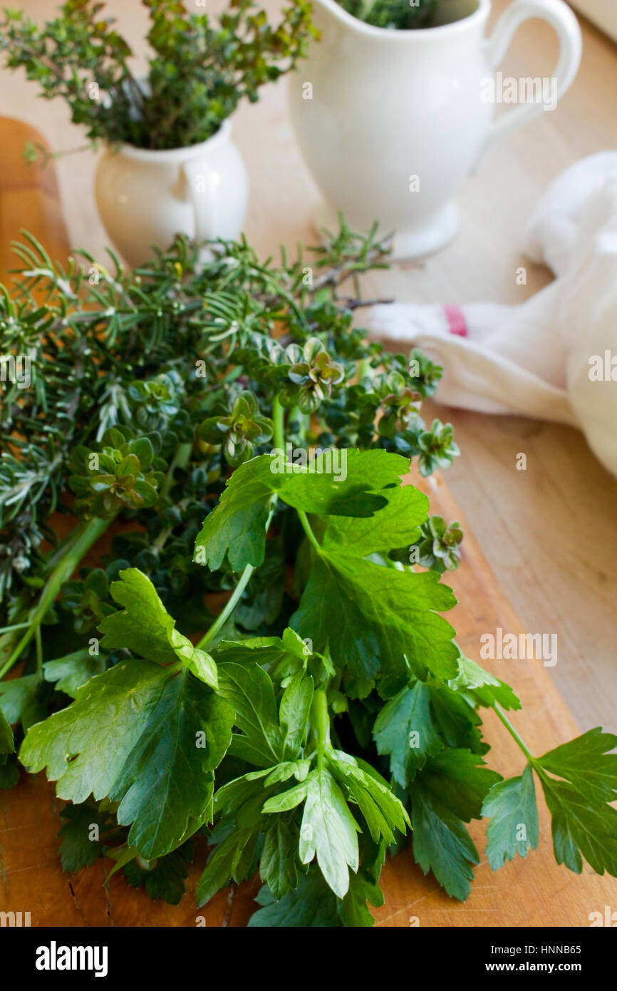 A bunch of freshly picked herbs on a chopping block Stock Photo - Alamy