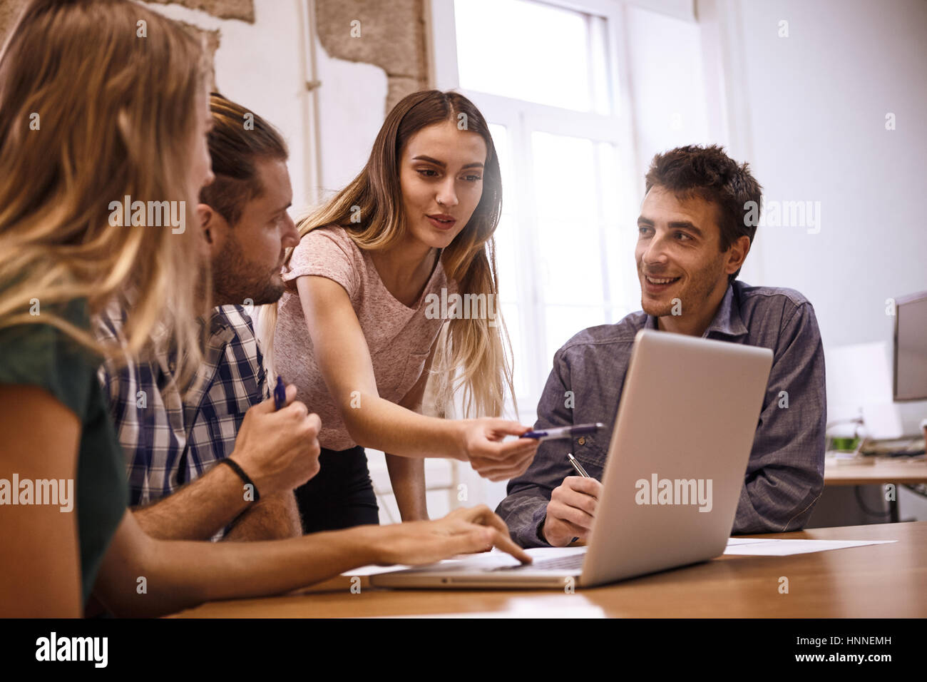 Professional young female presenter pointing to and explaining ...