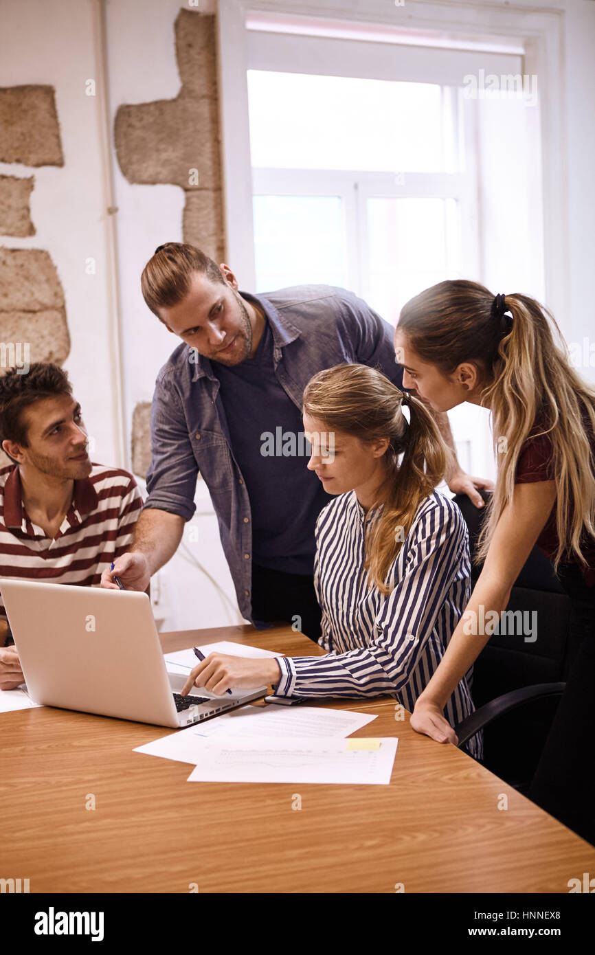 Young male professional explaining something to the business team while ...