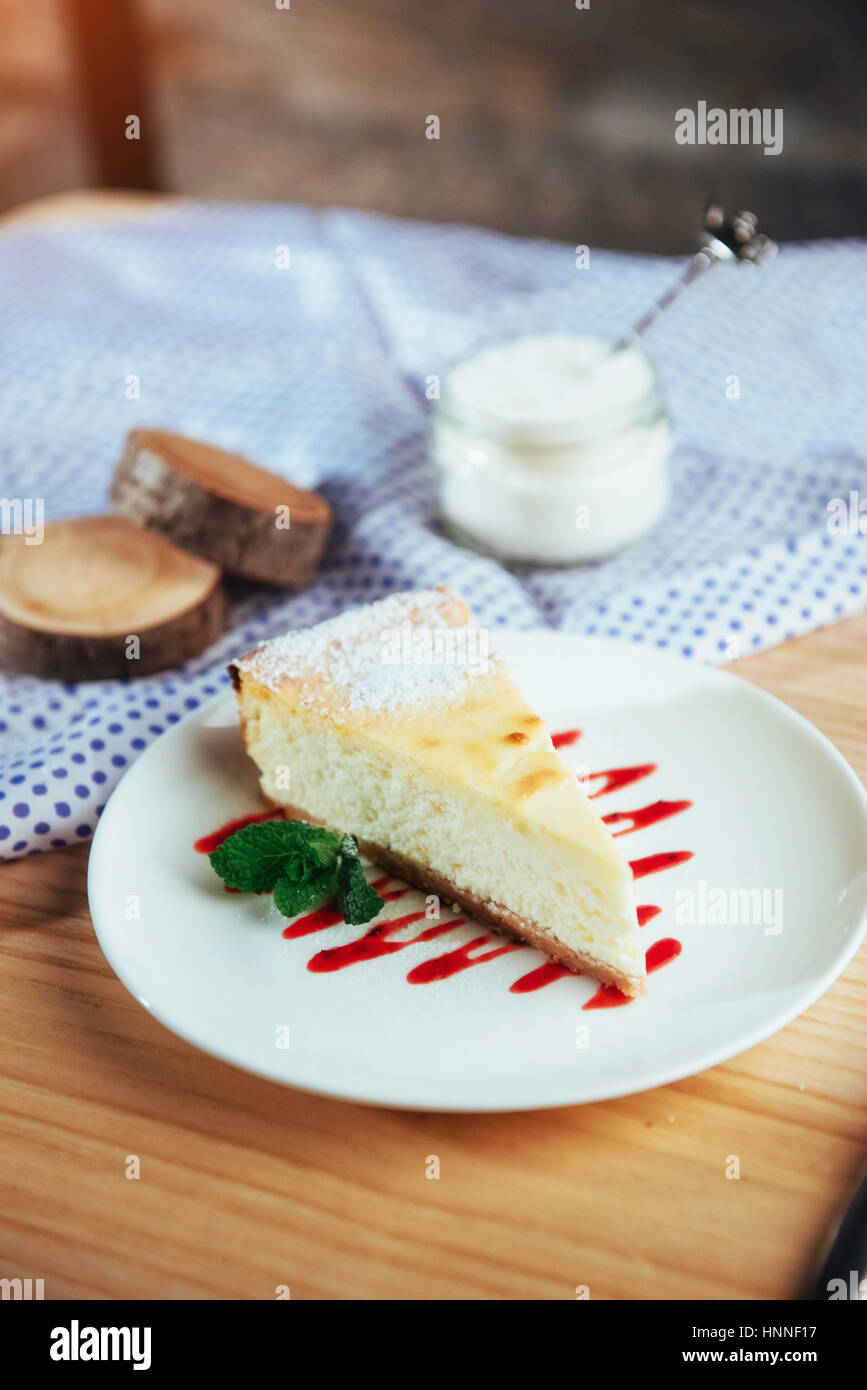 triangle cheese cakes in cafe. On a wooden table Stock Photo - Alamy