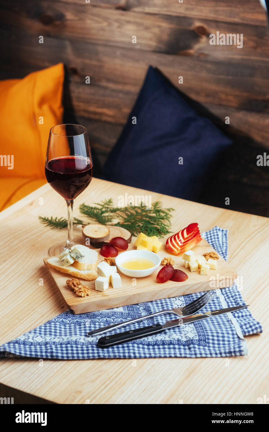 Red Wine And Assorted Cheese Plate with fruit Stock Photo - Alamy
