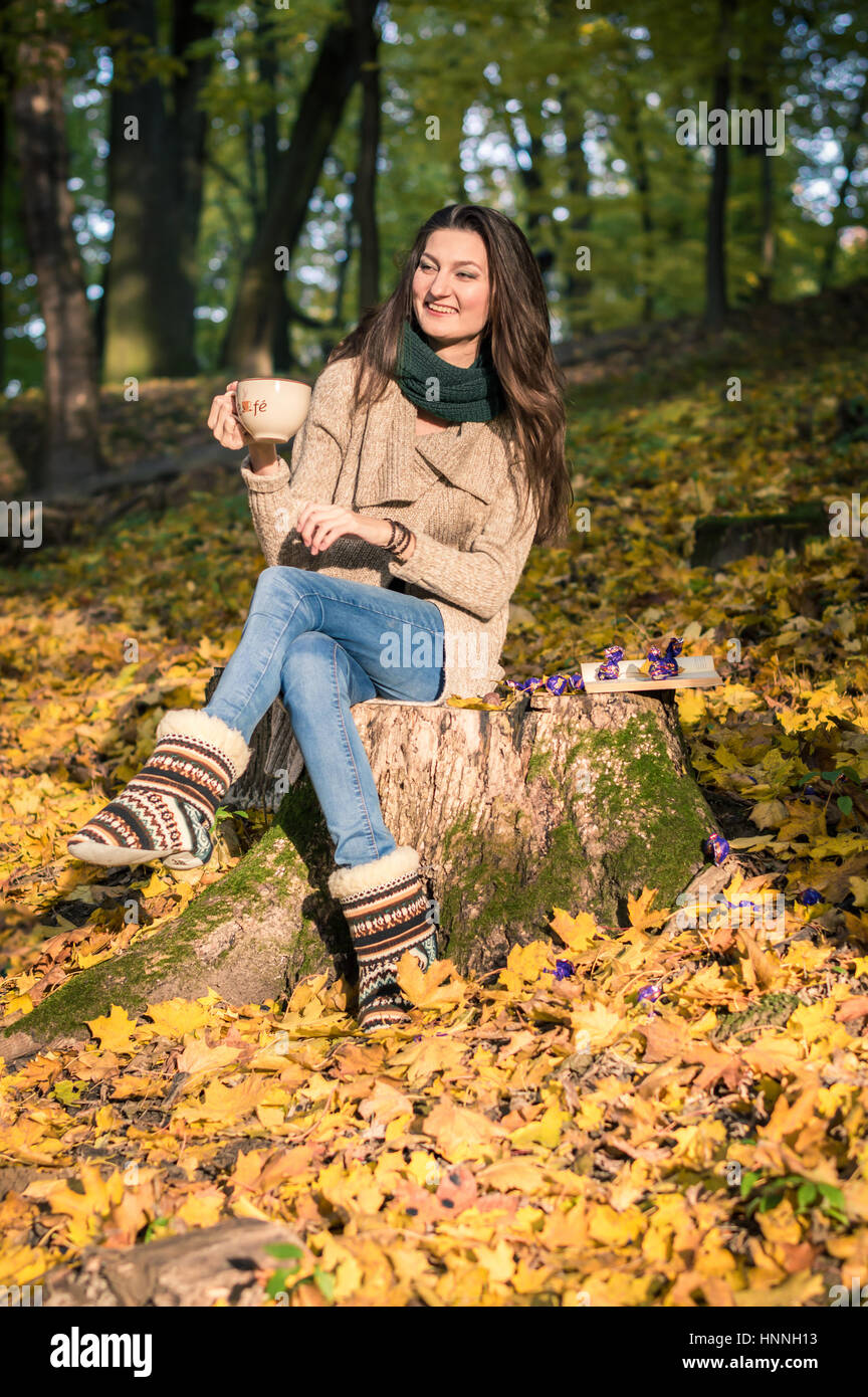 girl sitting on tree stump Stock Photo - Alamy
