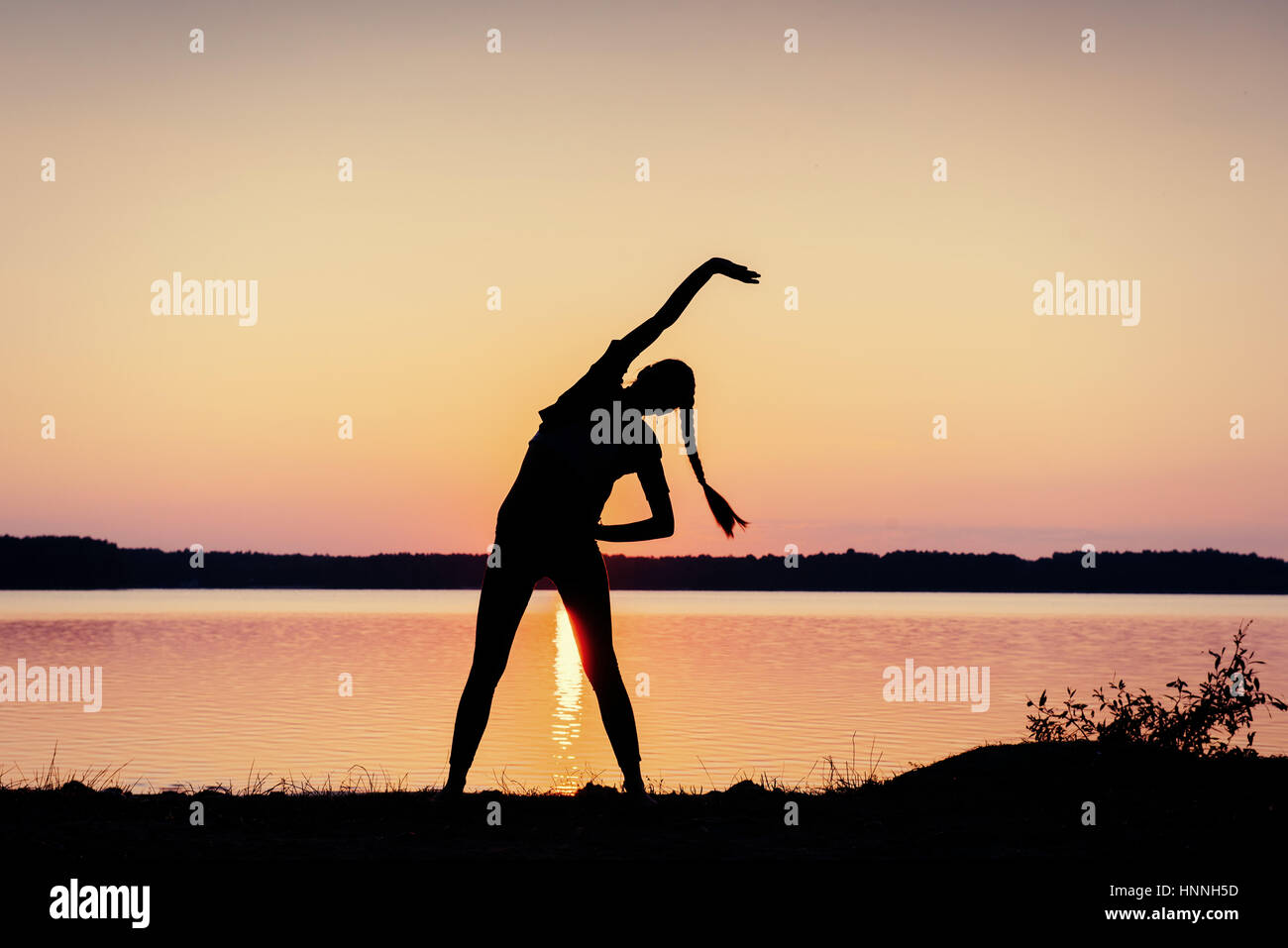 girl at sunset by the lake Stock Photo - Alamy