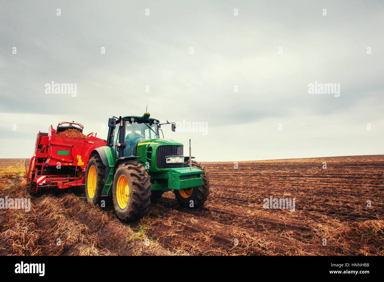 Tractor plowing farm field in preparation for spring planting Stock ...
